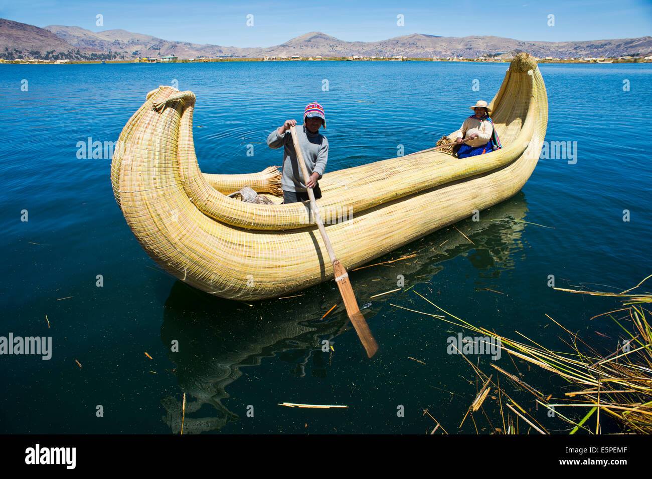 Two local in a traditional rowing boat of Totora reed on Lake Titicaca ...