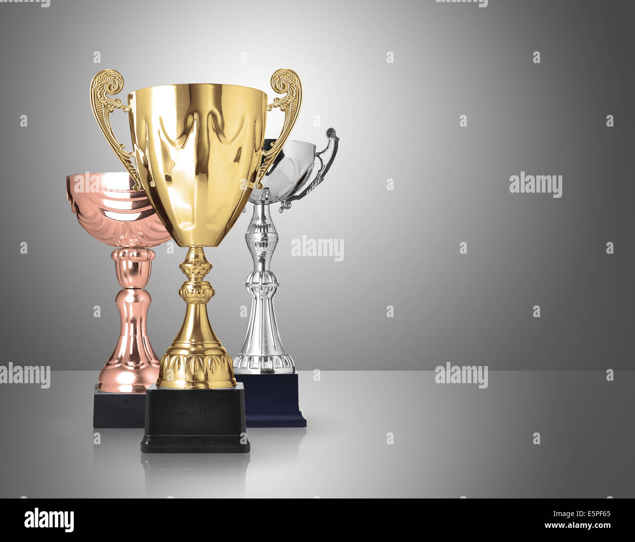 three different kind of trophies on gray background Stock Photo - Alamy