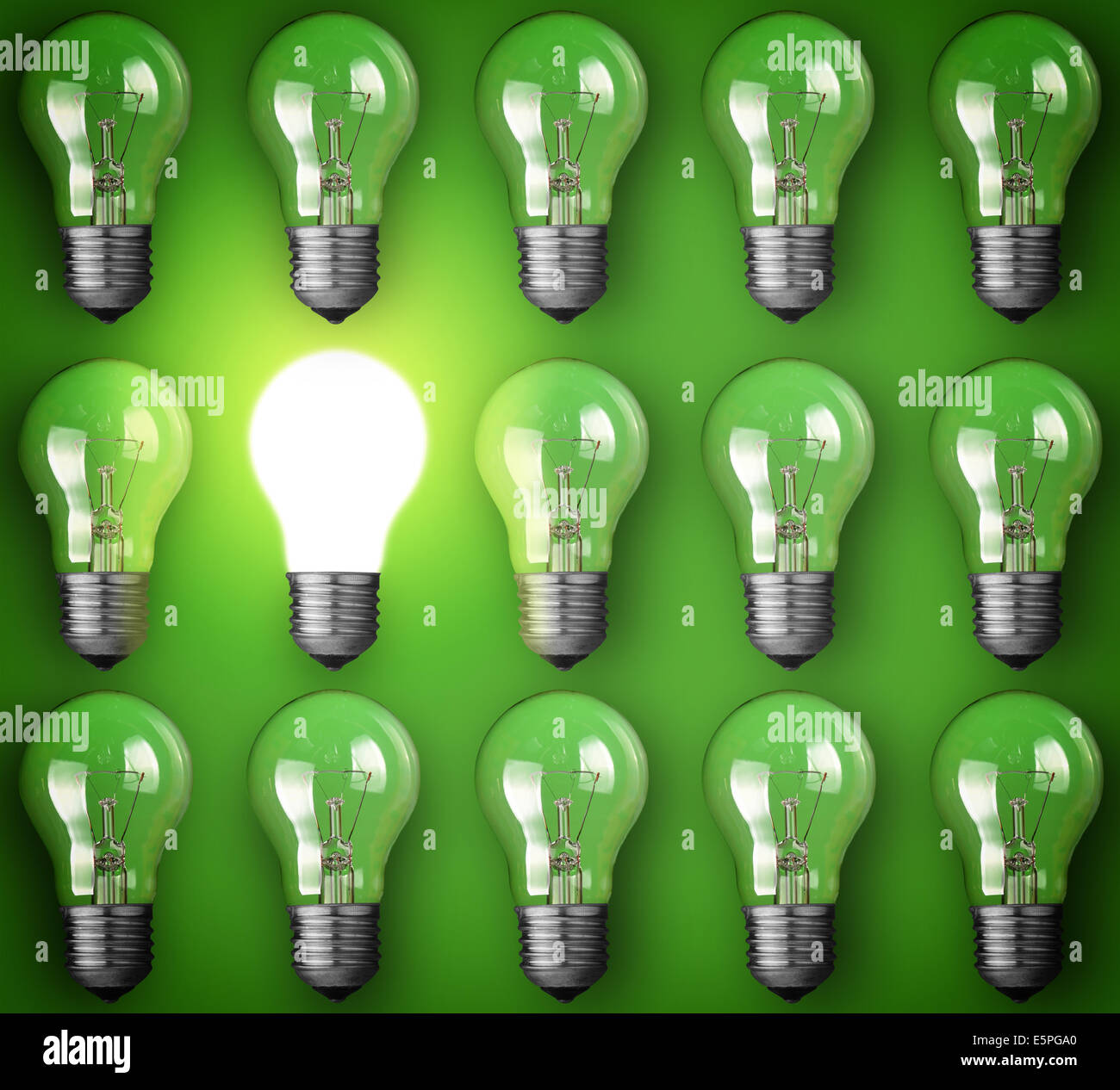 Idea concept with light bulbs on green background Stock Photo - Alamy