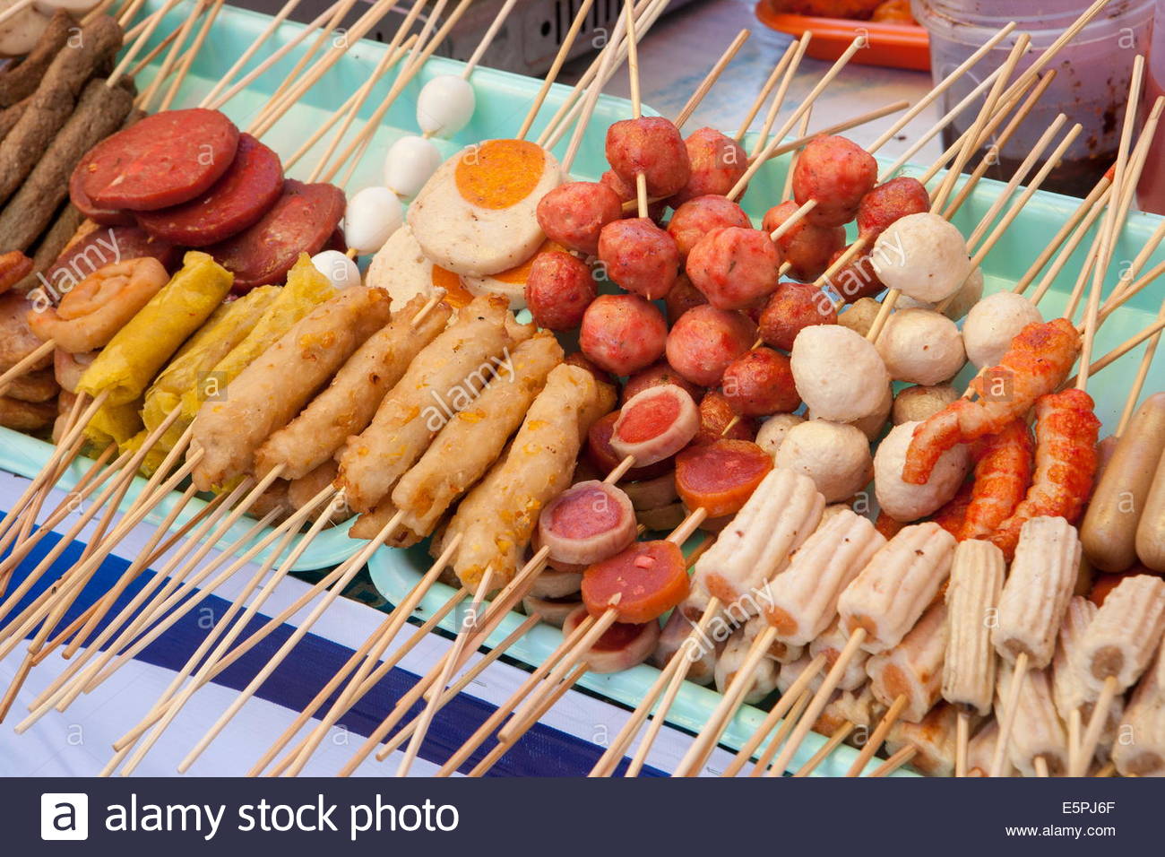 Traditional Burmese street food on bamboo skewers ready for barbecue ...