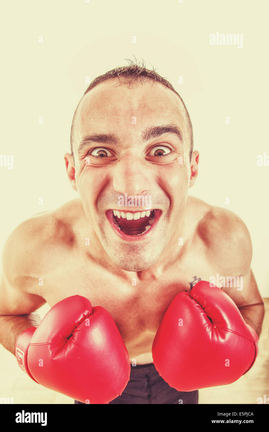 funny portrait of a confused and astonished man with red boxing gloves ...