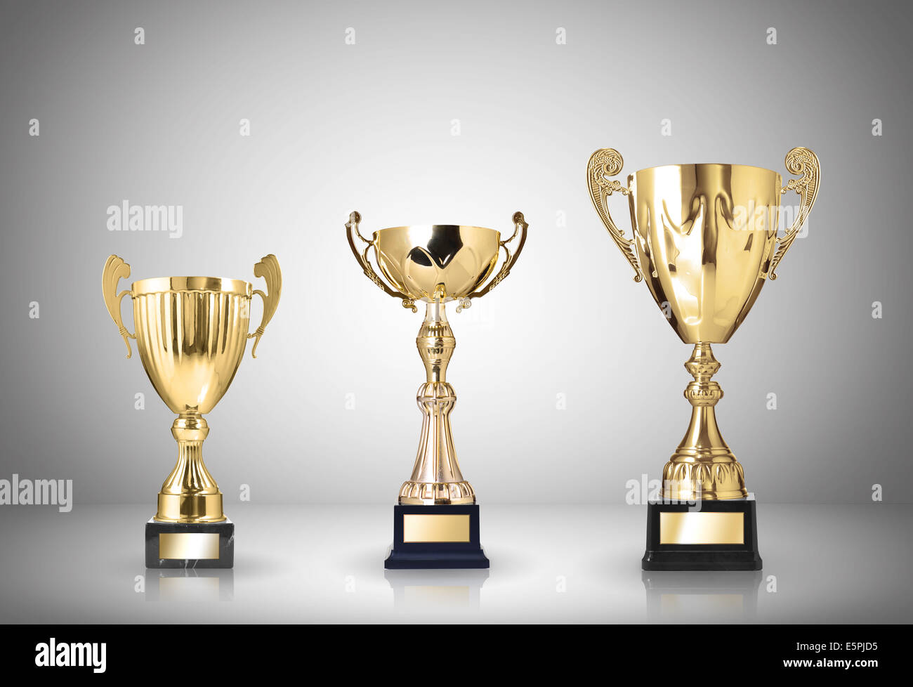 golden trophies on gray background Stock Photo - Alamy