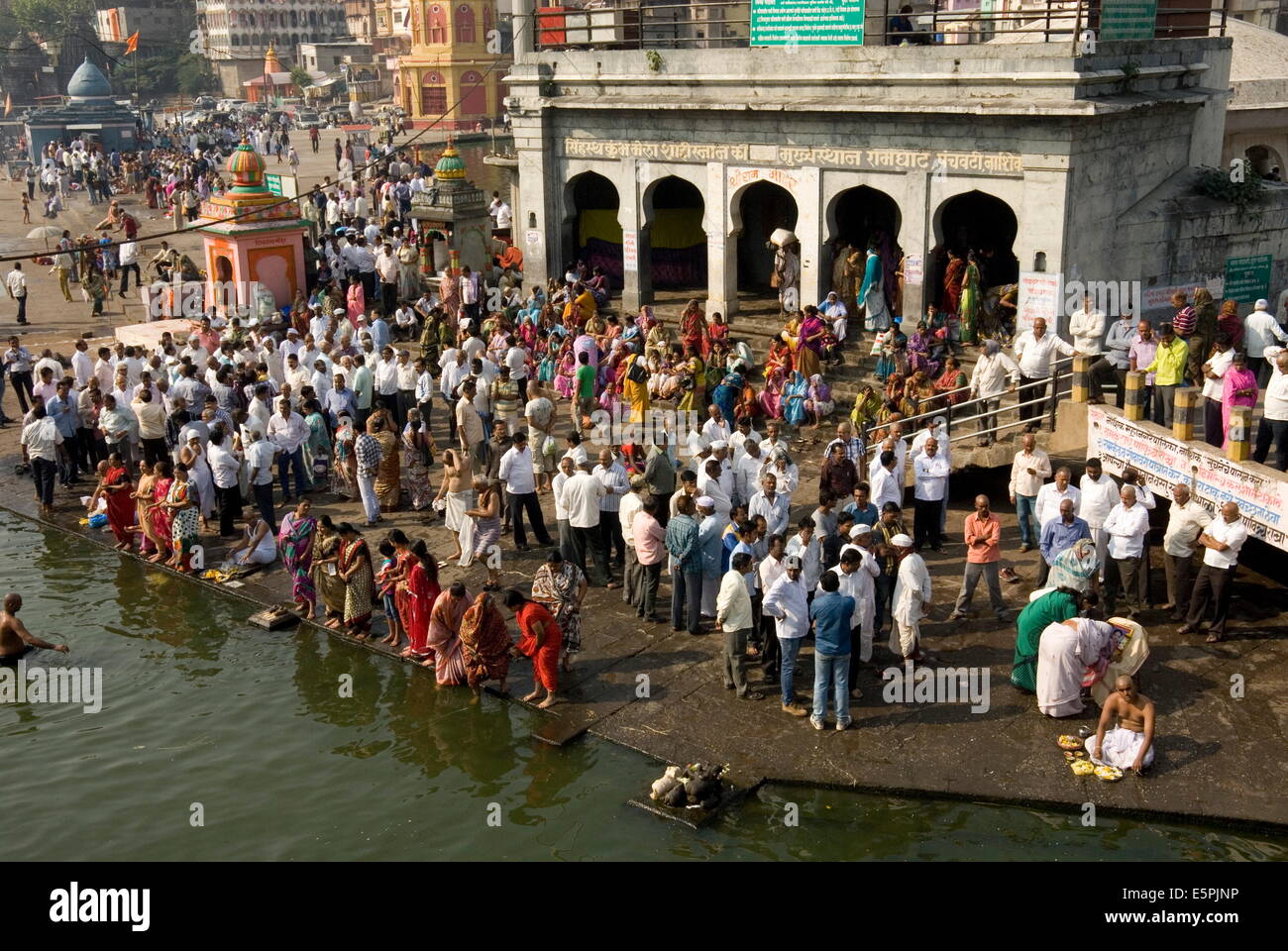 Worshippers at the Ramkund tank on the ghats along the holy River ...