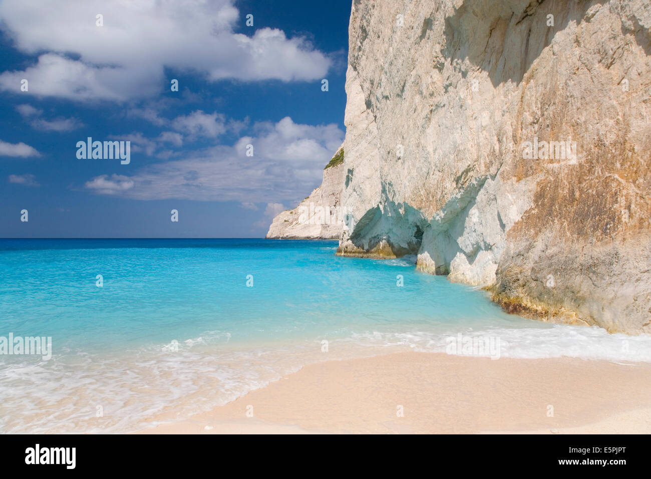 Limestone cliffs towering above the sea, Navagio Bay, Anafonitria ...