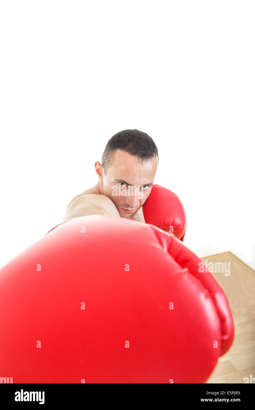 muscular determined man with red boxing gloves hiting to camera Stock ...