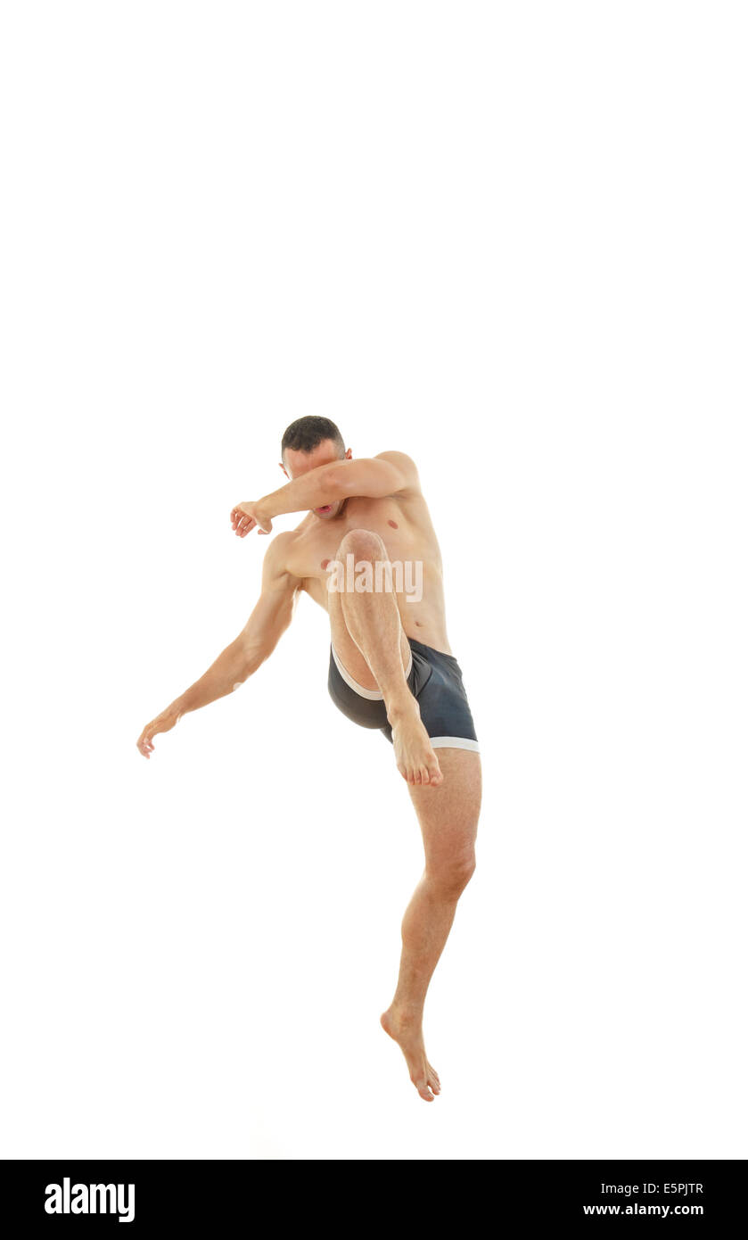 Sportsman kick boxer fighting with a kick in full length portrait ...