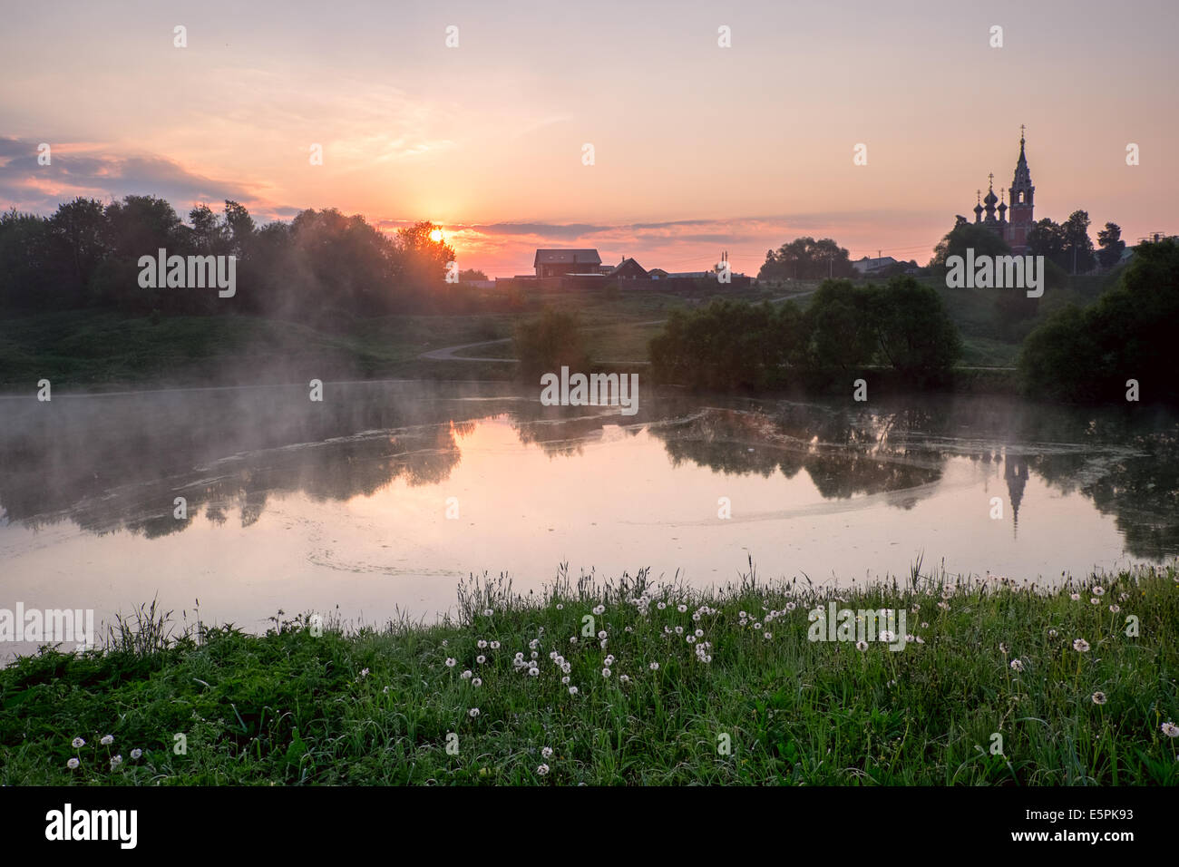 Early morning sunrise village in Russia. Landscape with a church at the ...