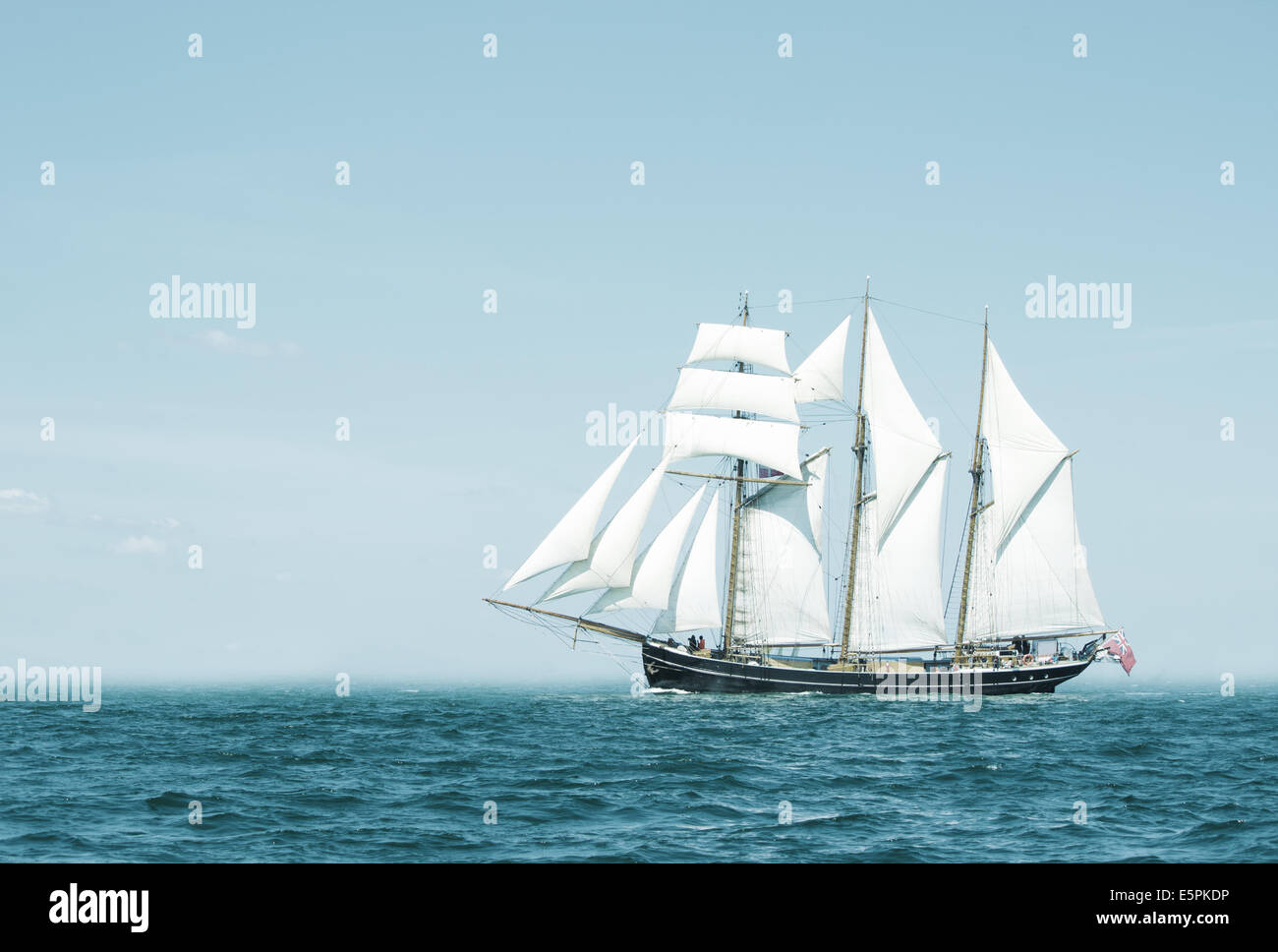 Three mast schooner under sails on the baltic sea. Cross processed ...