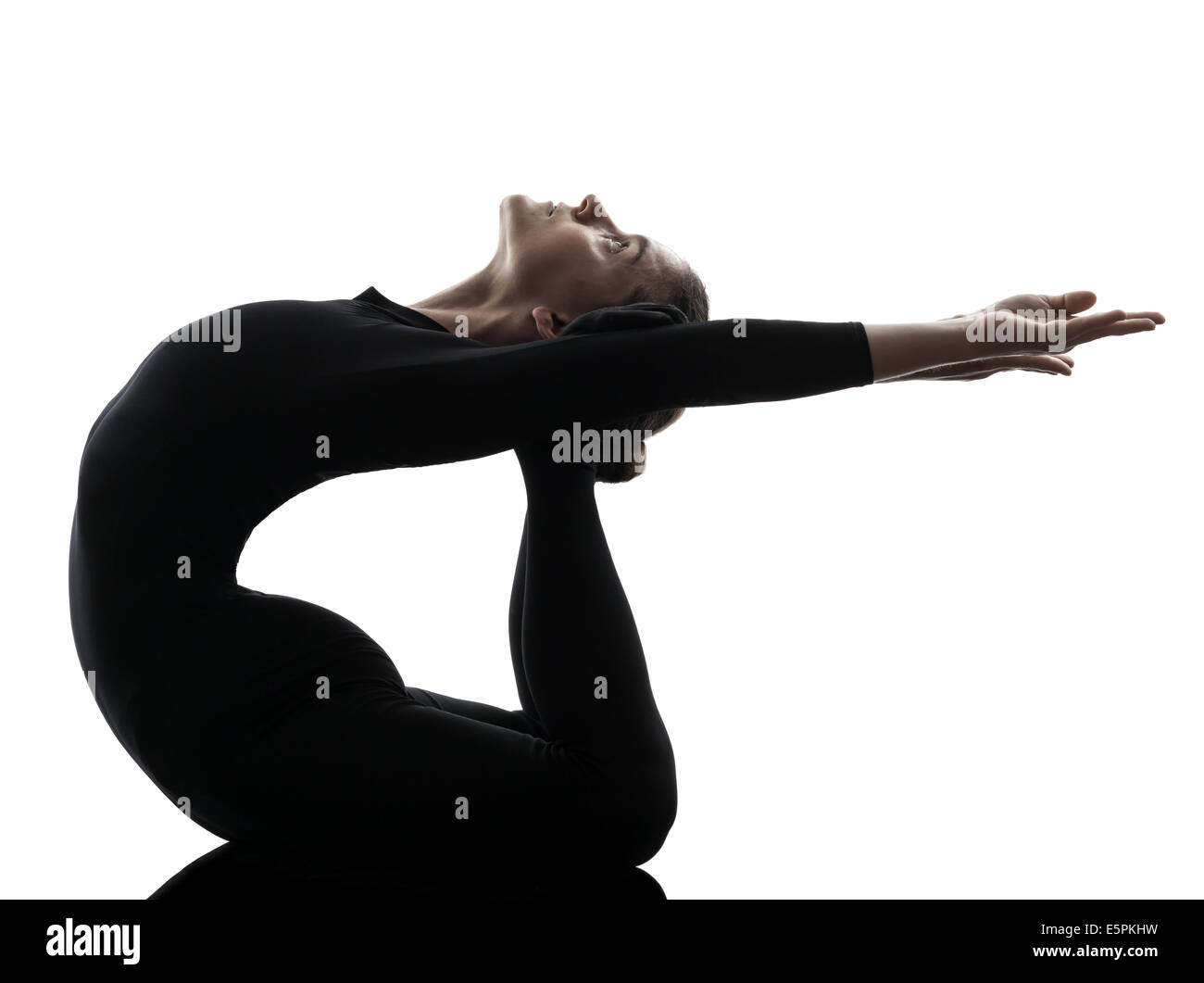 one woman contortionist practicing gymnastic yoga in silhouette on ...