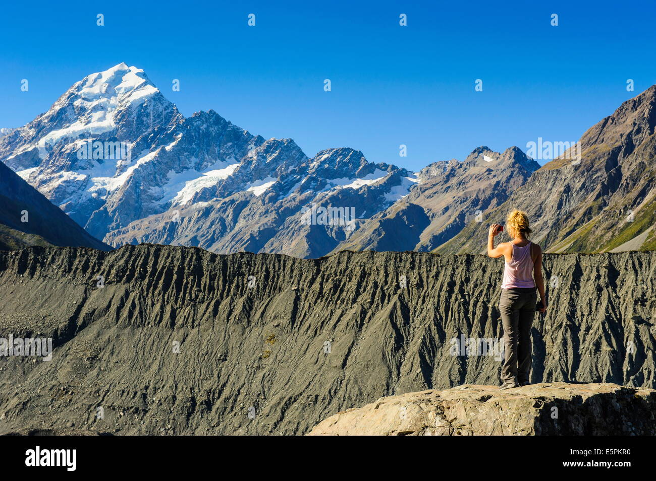 Woman photographing Mount Cook, South Island, New Zealand Stock Photo ...