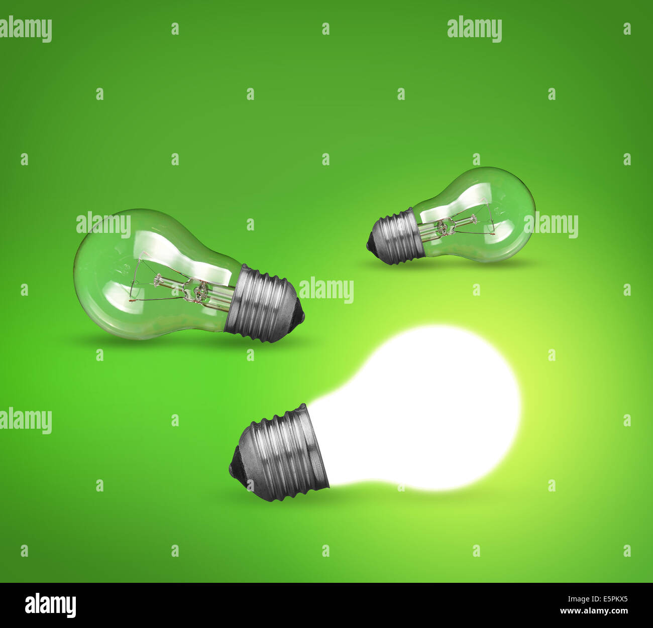 idea concept with glowing light bulb on green background Stock Photo ...