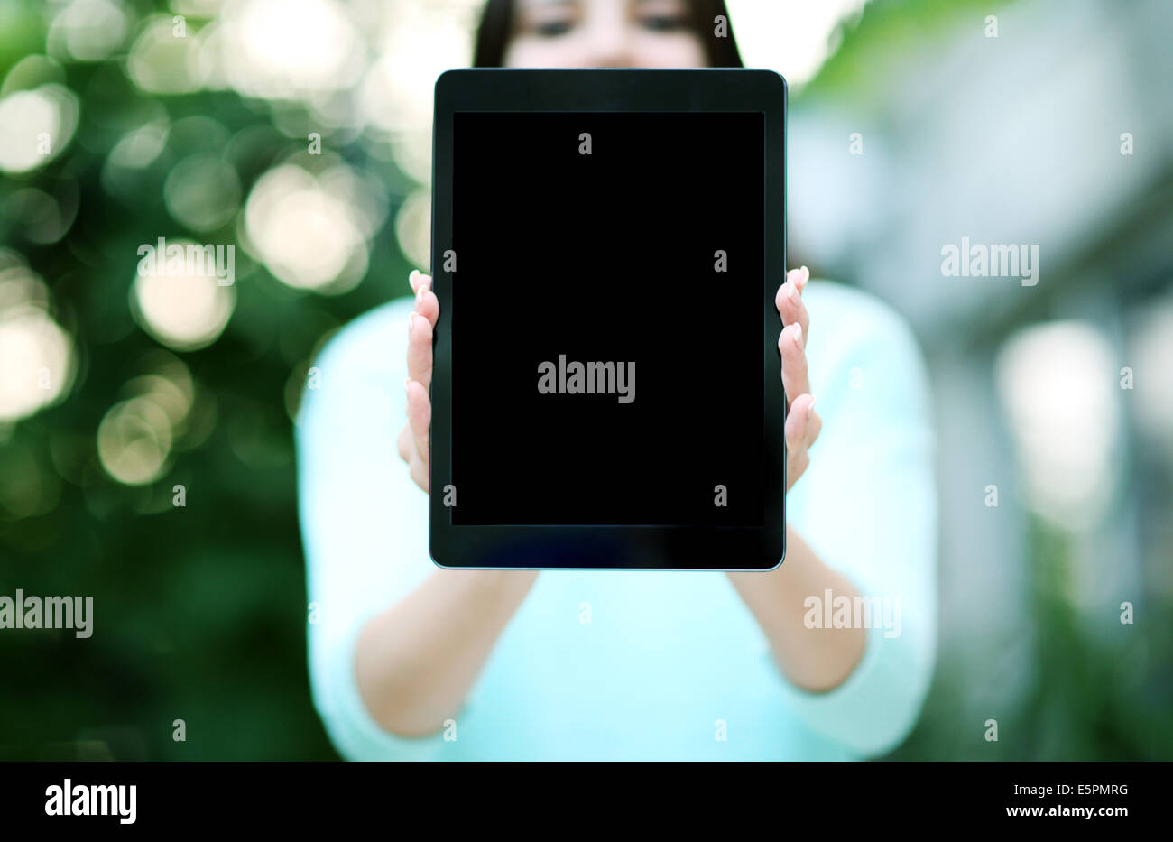 Closeup portrait of a female hands holding tablet computer with blank ...