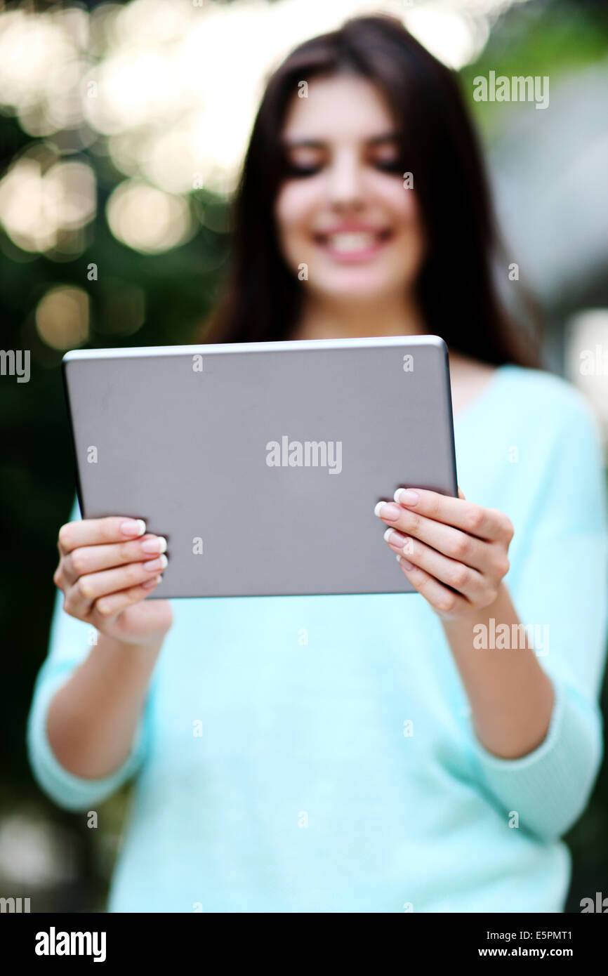 Portrait of a woman holding tablet computer. Focus on tablet computer ...