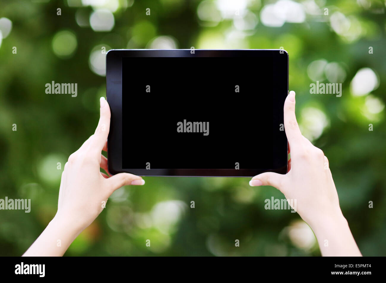 Closeup portrait of a female hands holding tablet computer with blank ...