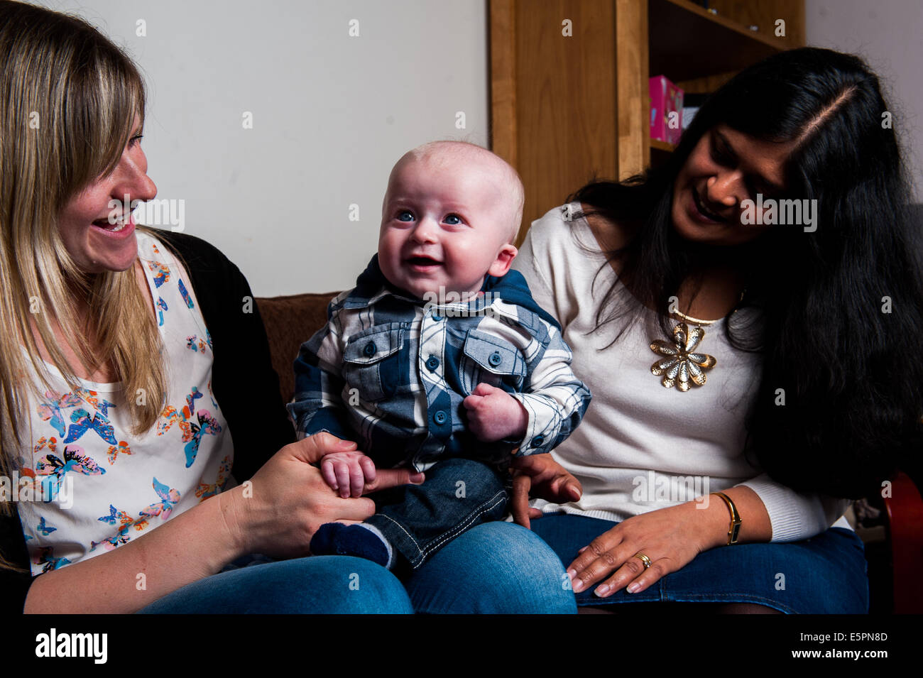 Mums posing at home with baby Stock Photo - Alamy
