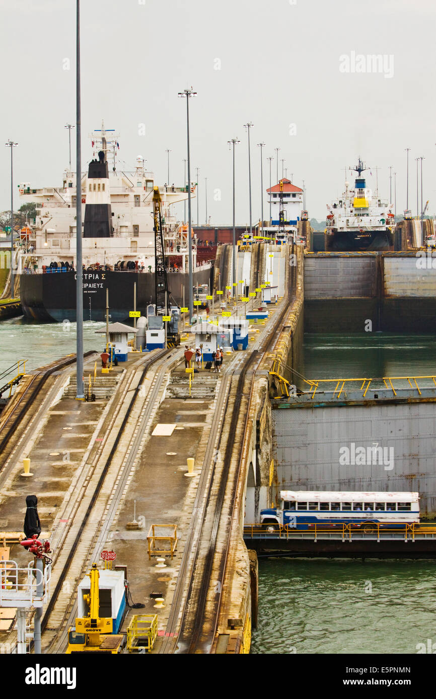 Two ships in Gatun locks below Gatun Lake with school bus crossing lock ...