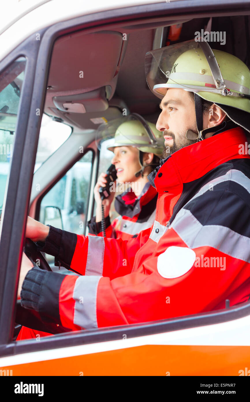 Emergency doctor and nurse driving ambulance Stock Photo - Alamy