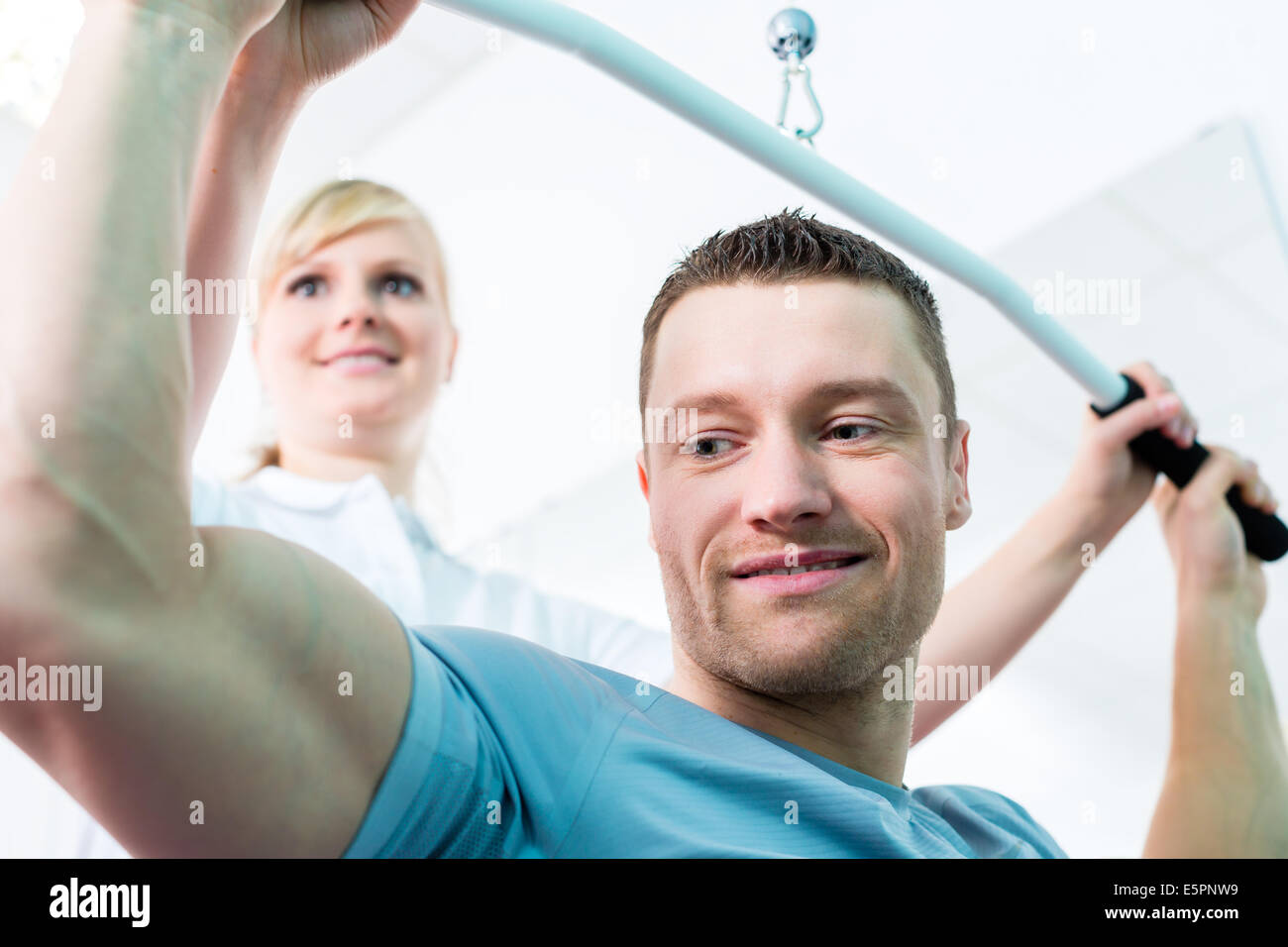 Patient at the physiotherapy doing physical exercises with therapist in ...