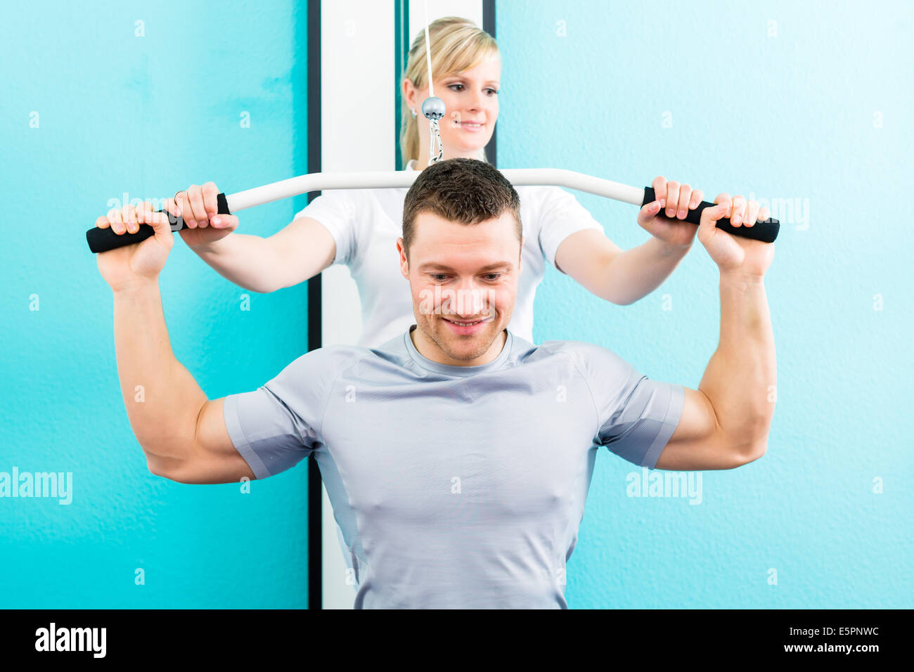 Patient at the physiotherapy doing physical exercises with therapist in ...