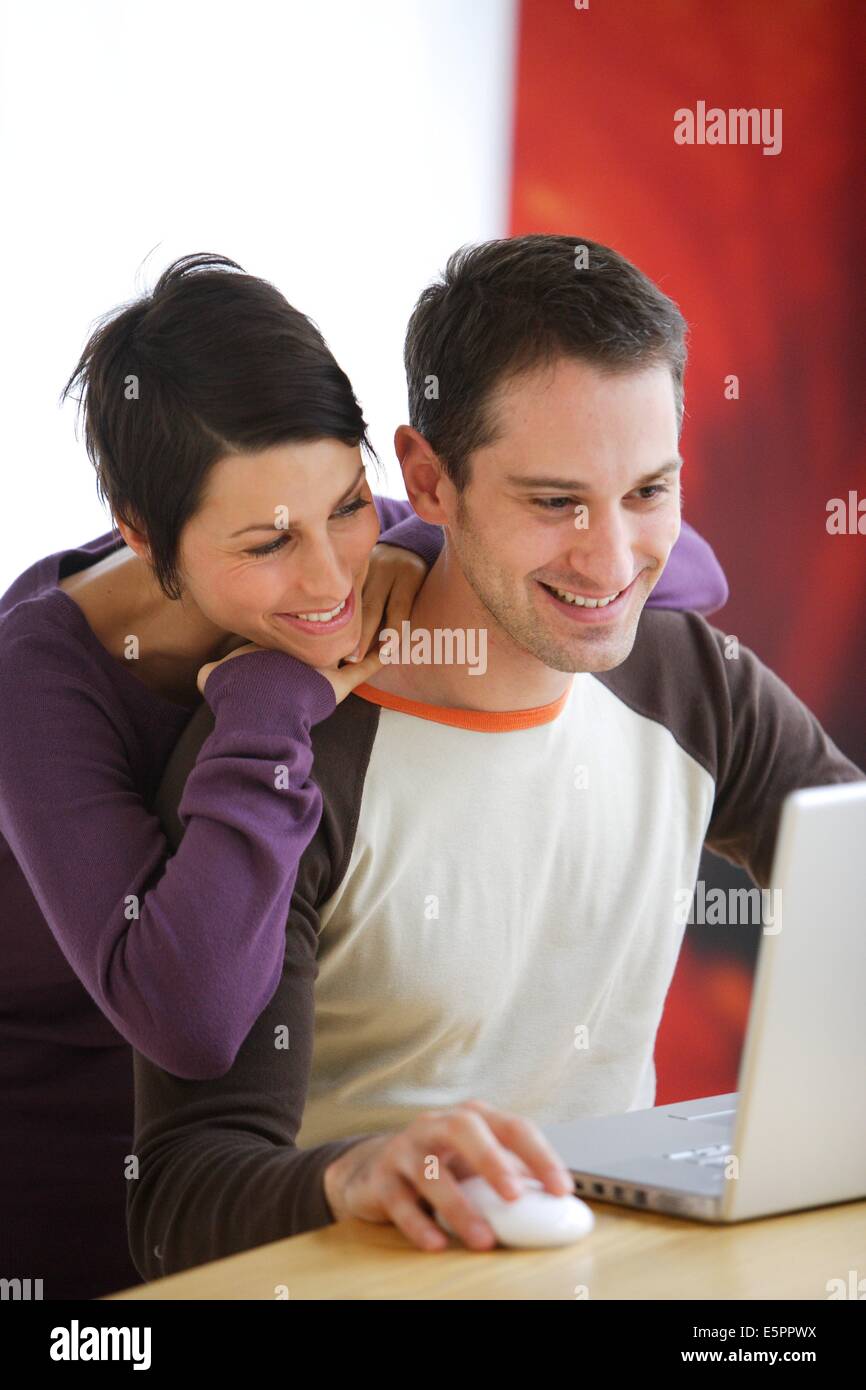 Couple using laptop computer Stock Photo - Alamy