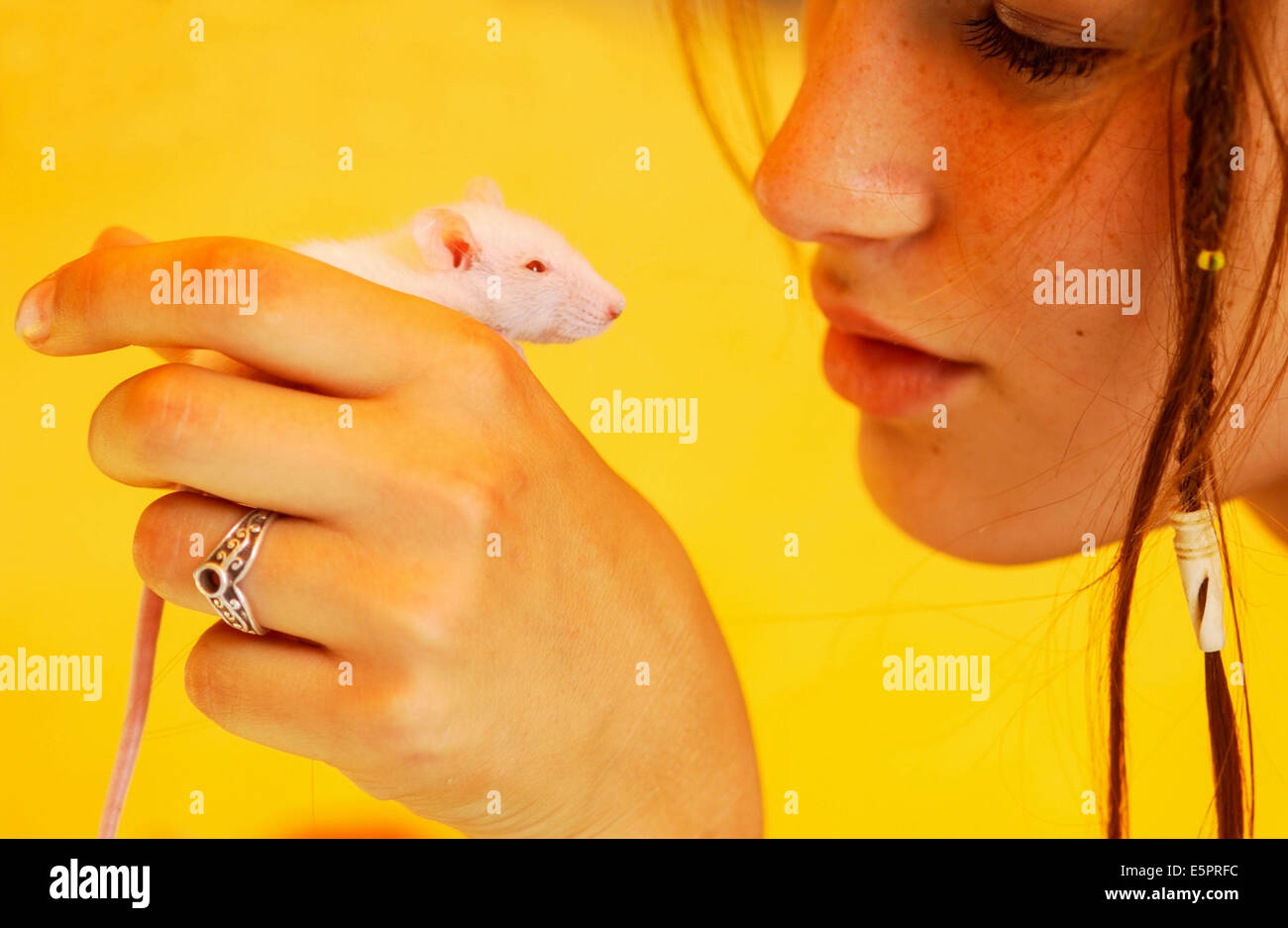 Teenage girl with a mouse as pet Stock Photo - Alamy