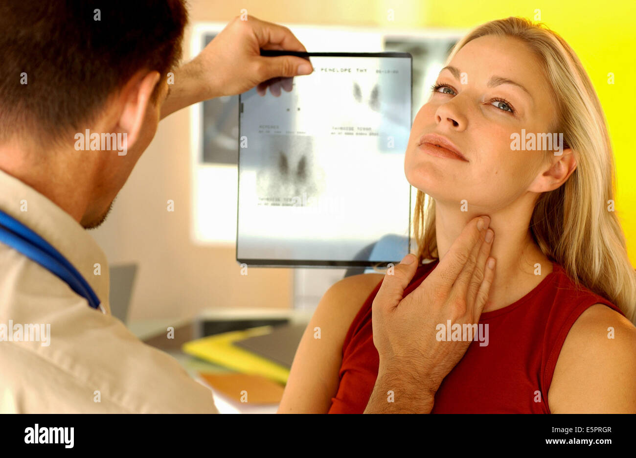 Doctor examining the thyroid gland of a patient Stock Photo - Alamy