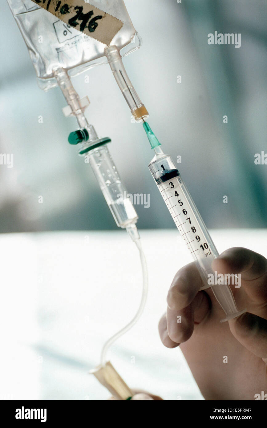 Injection of medication in to a drip system Stock Photo - Alamy