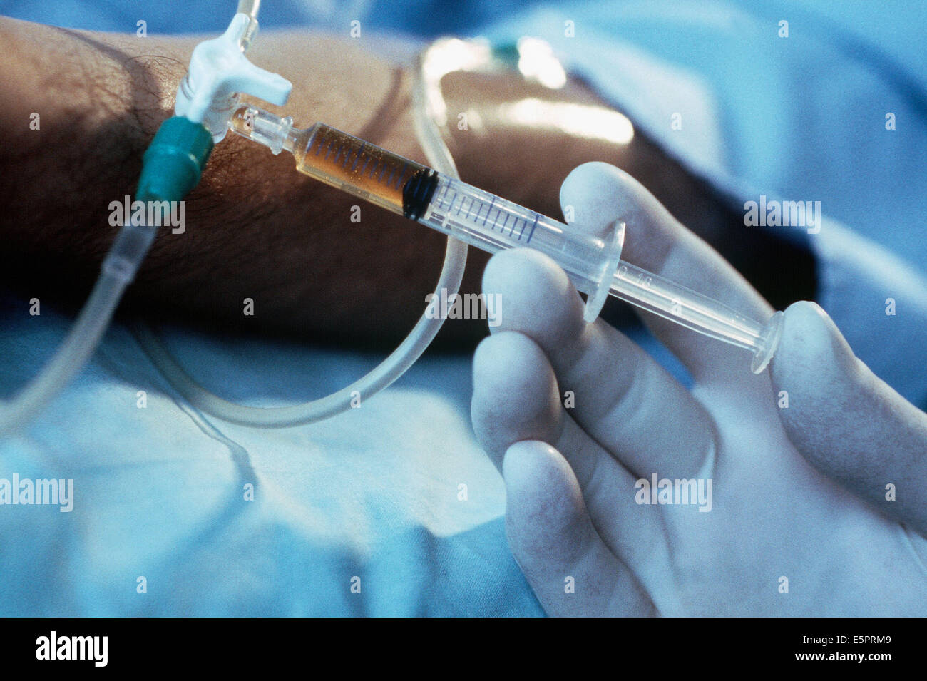 Injection of medication in to a drip system Stock Photo - Alamy