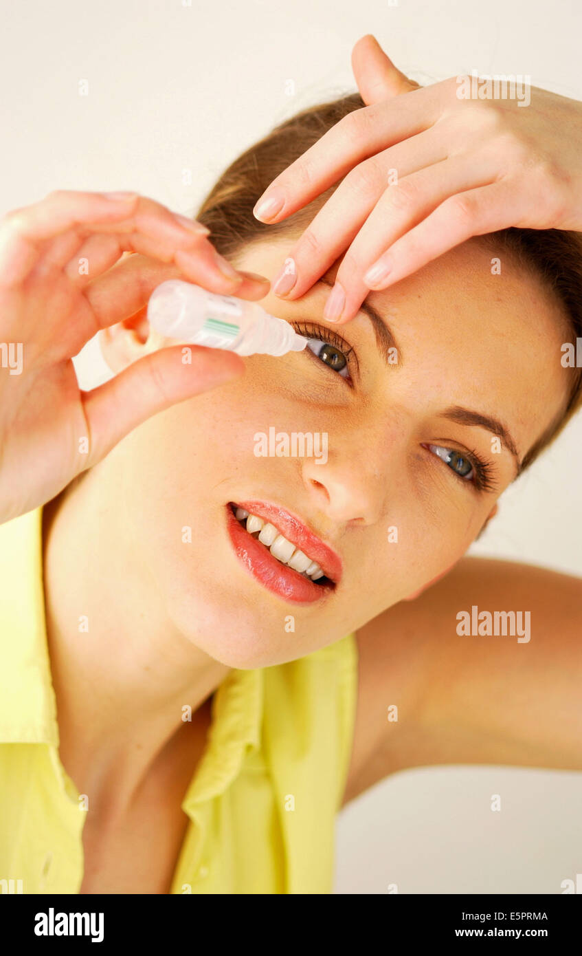 Woman applying eye-drops into her eye Stock Photo - Alamy