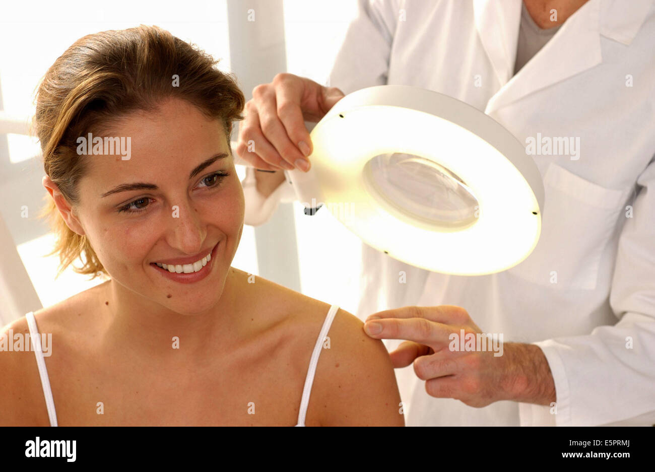 Professional dermatologist using magnifying hi-res stock photography ...