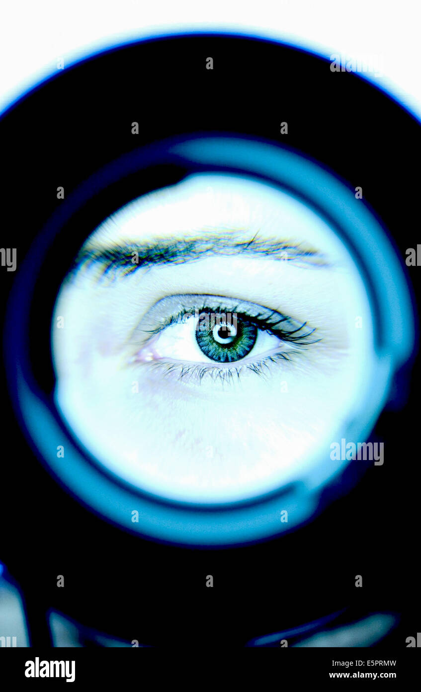 Dermatologist using a magnifying lens to examine the skin of a patient ...