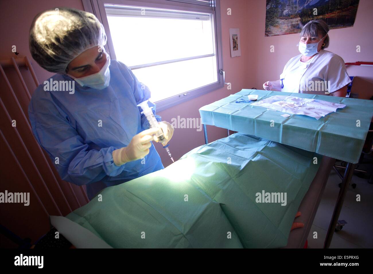 A doctor is filling an implanted insulin pump of a patient, Department ...