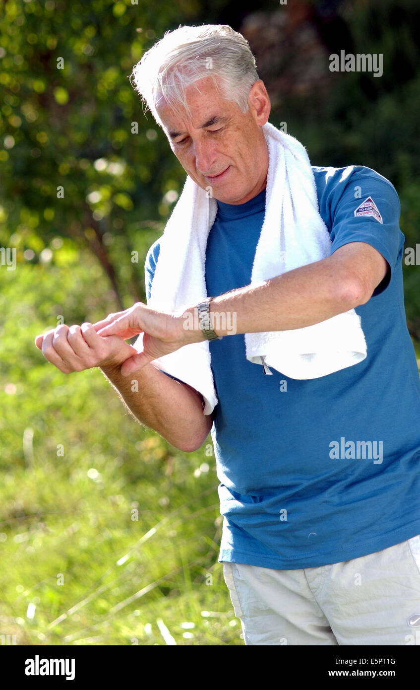 60-year-old man checking his pulse after physical activity Stock Photo ...