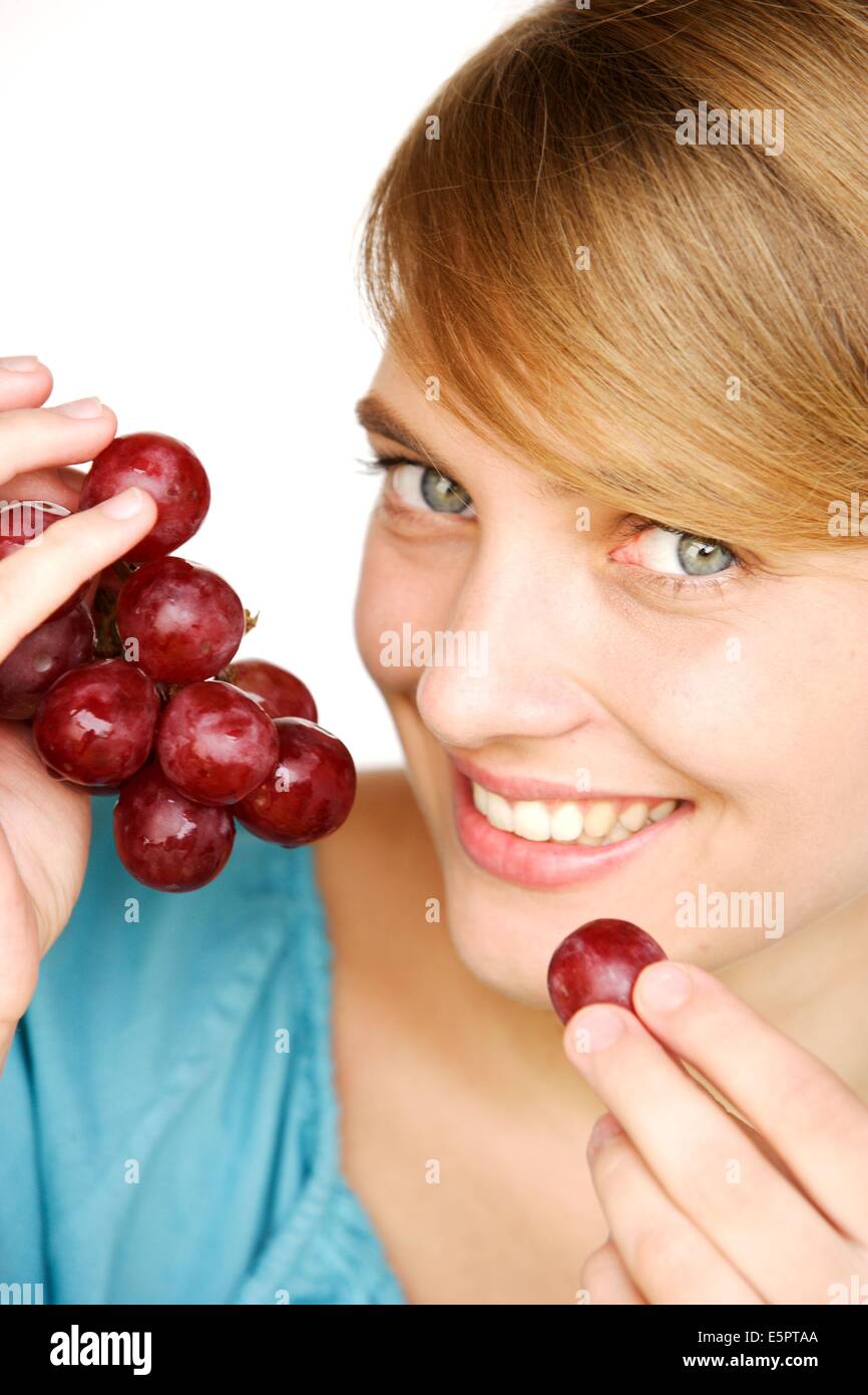 Woman eating grape Stock Photo - Alamy