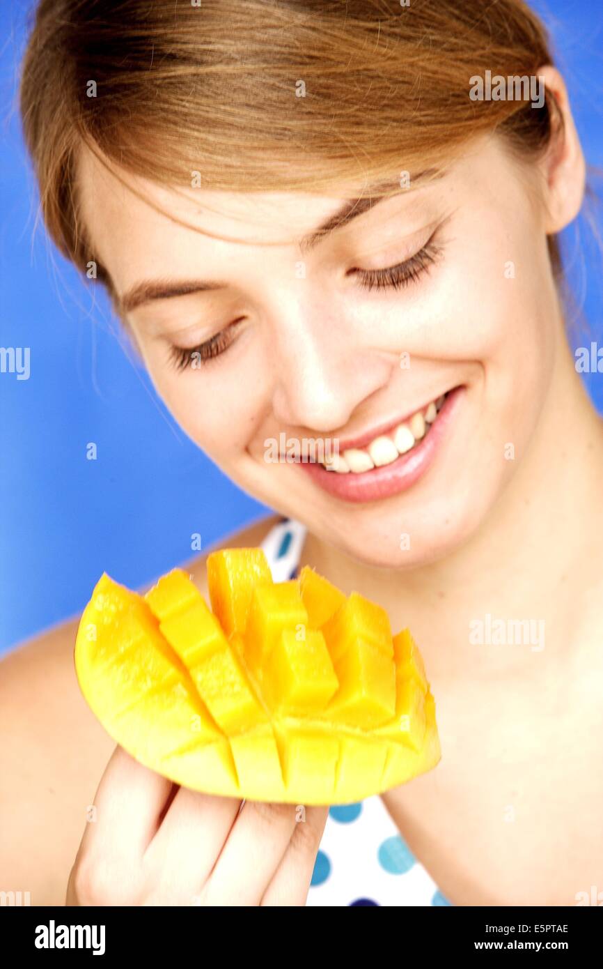 Woman eating mango Stock Photo - Alamy