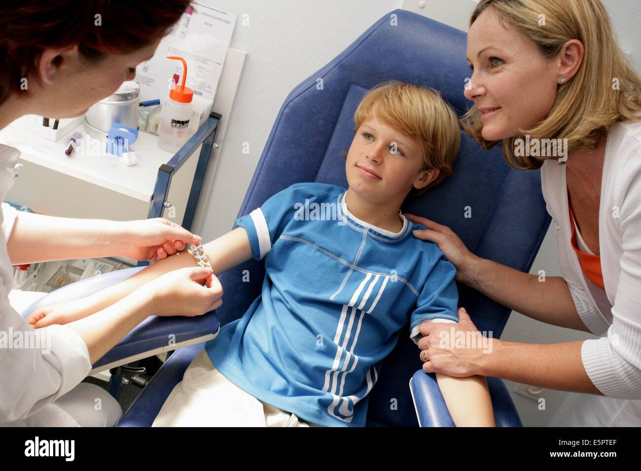 Nurse taking 8-year-old boy's blood sample Stock Photo - Alamy