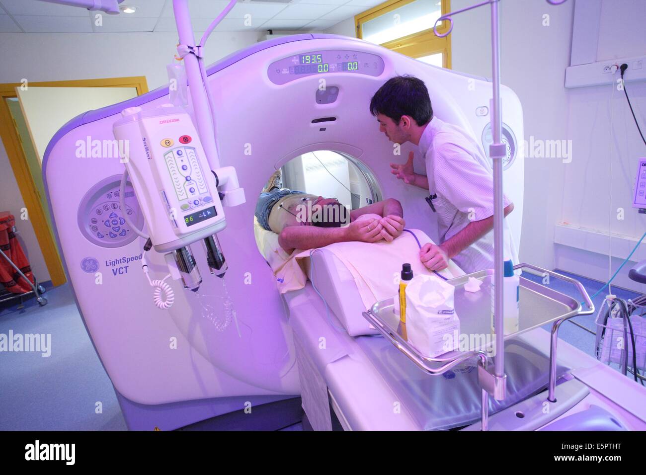 Patient undergoing 3D Computed Tomography (CT) scan of the heart with a ...