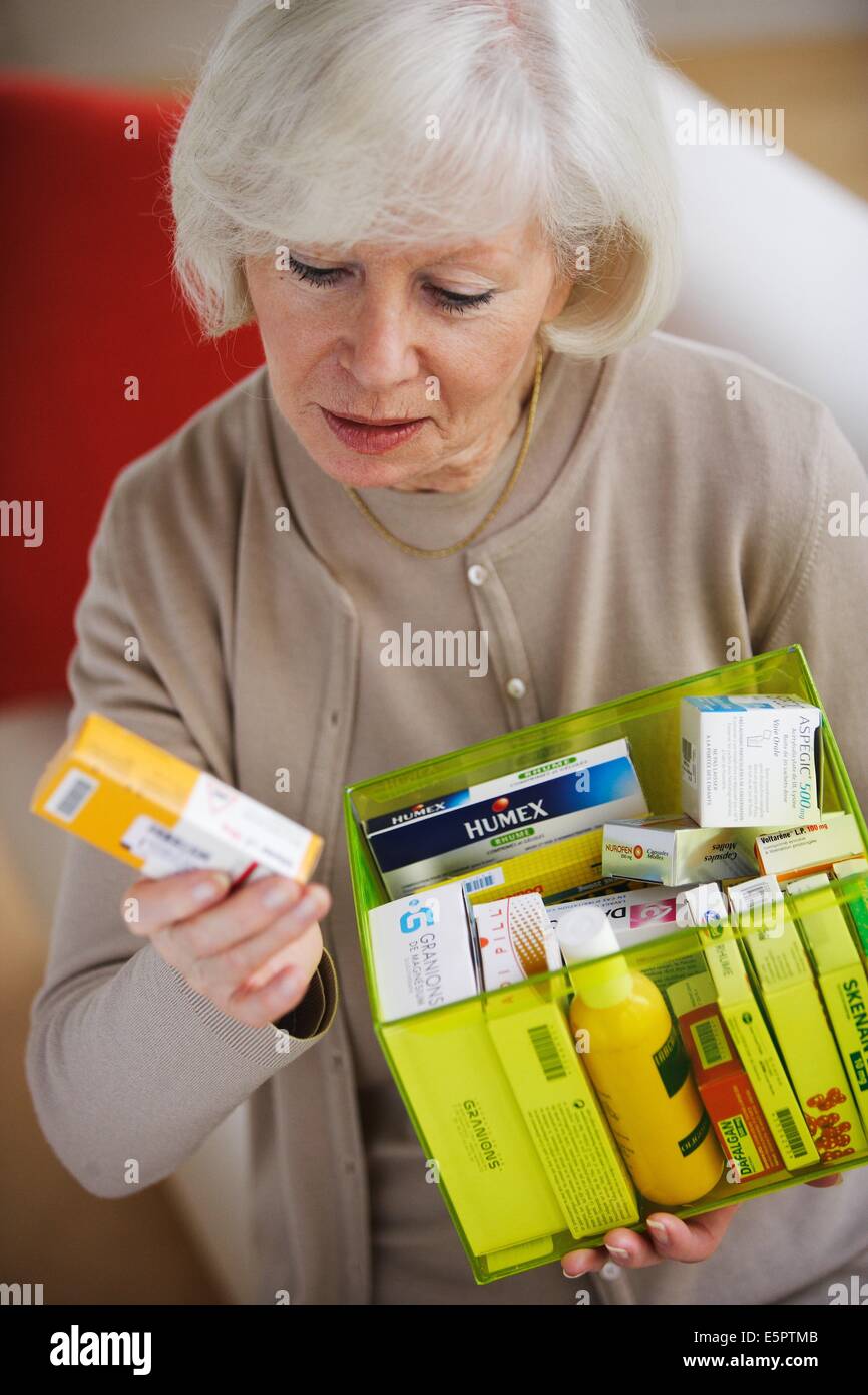 Elderly woman taking medicine from drug box Stock Photo - Alamy