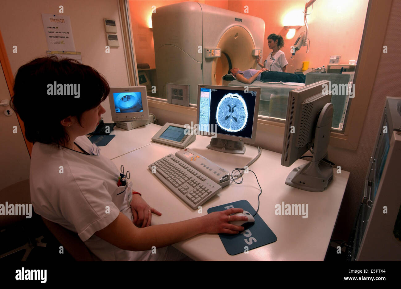 Technician monitoring a patient undergoing a Computed Tomography (CT ...