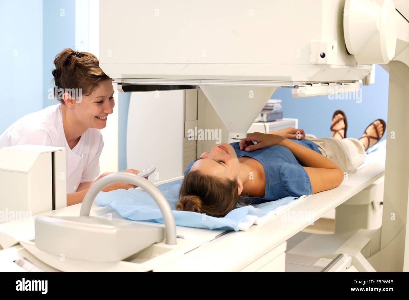Young woman undergoing a gamma scan examination of the thyroid at the ...