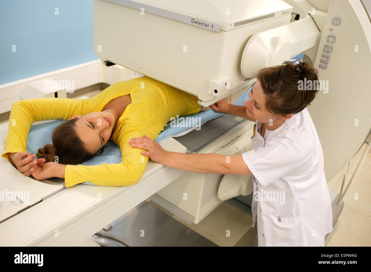 Young woman undergoing a gamma scan examination of her bones at the ...