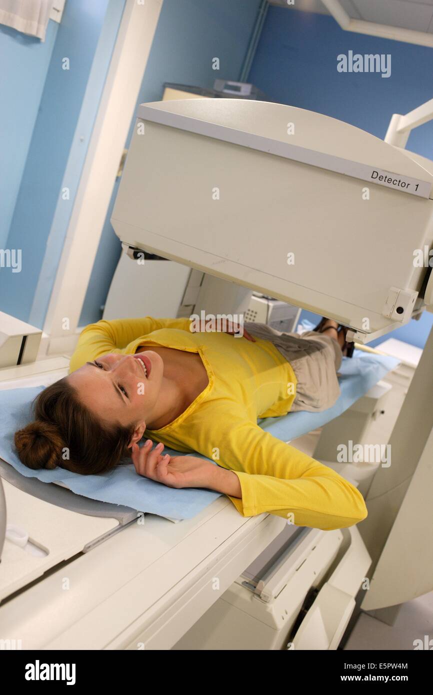 Young woman undergoing a gamma scan examination of her bones at the ...