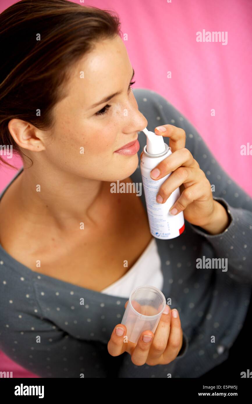Woman using a sterile sea water spray Stock Photo - Alamy