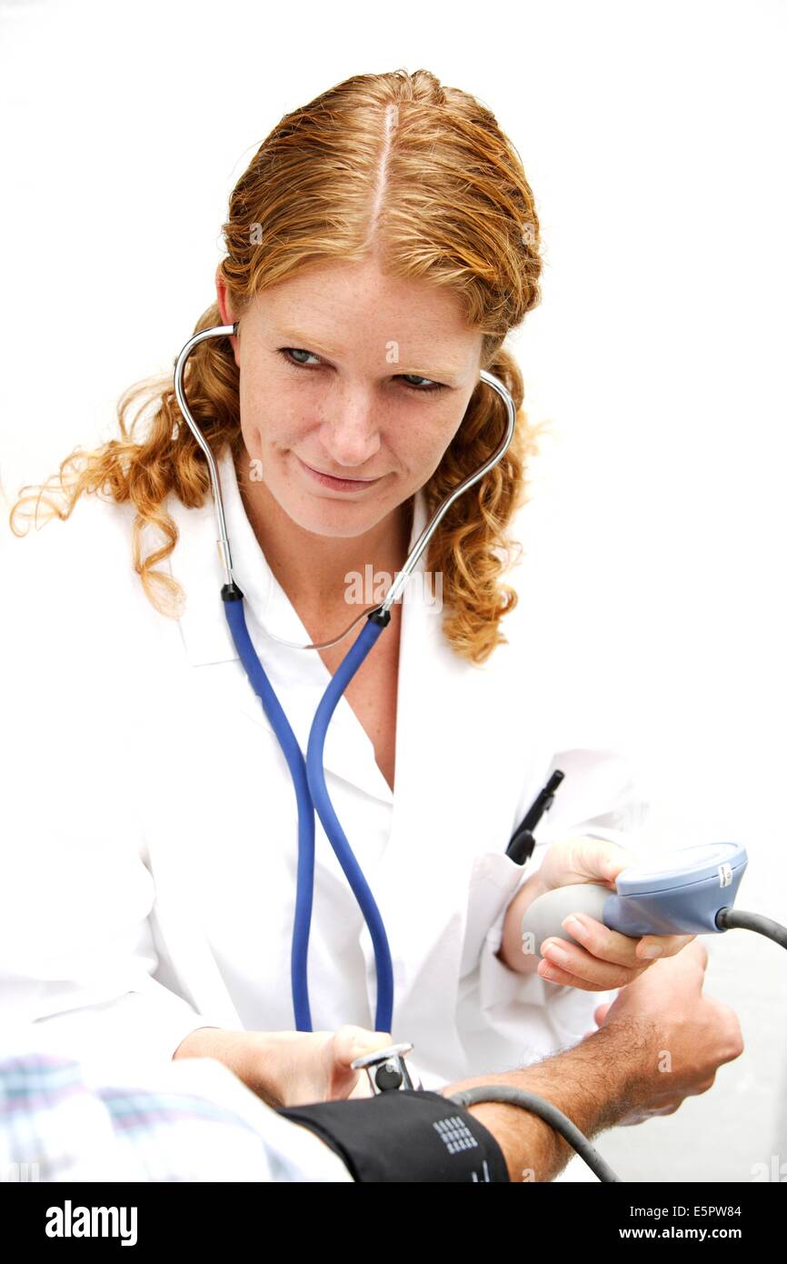 Female doctor checking the blood pressure of a patient Stock Photo - Alamy