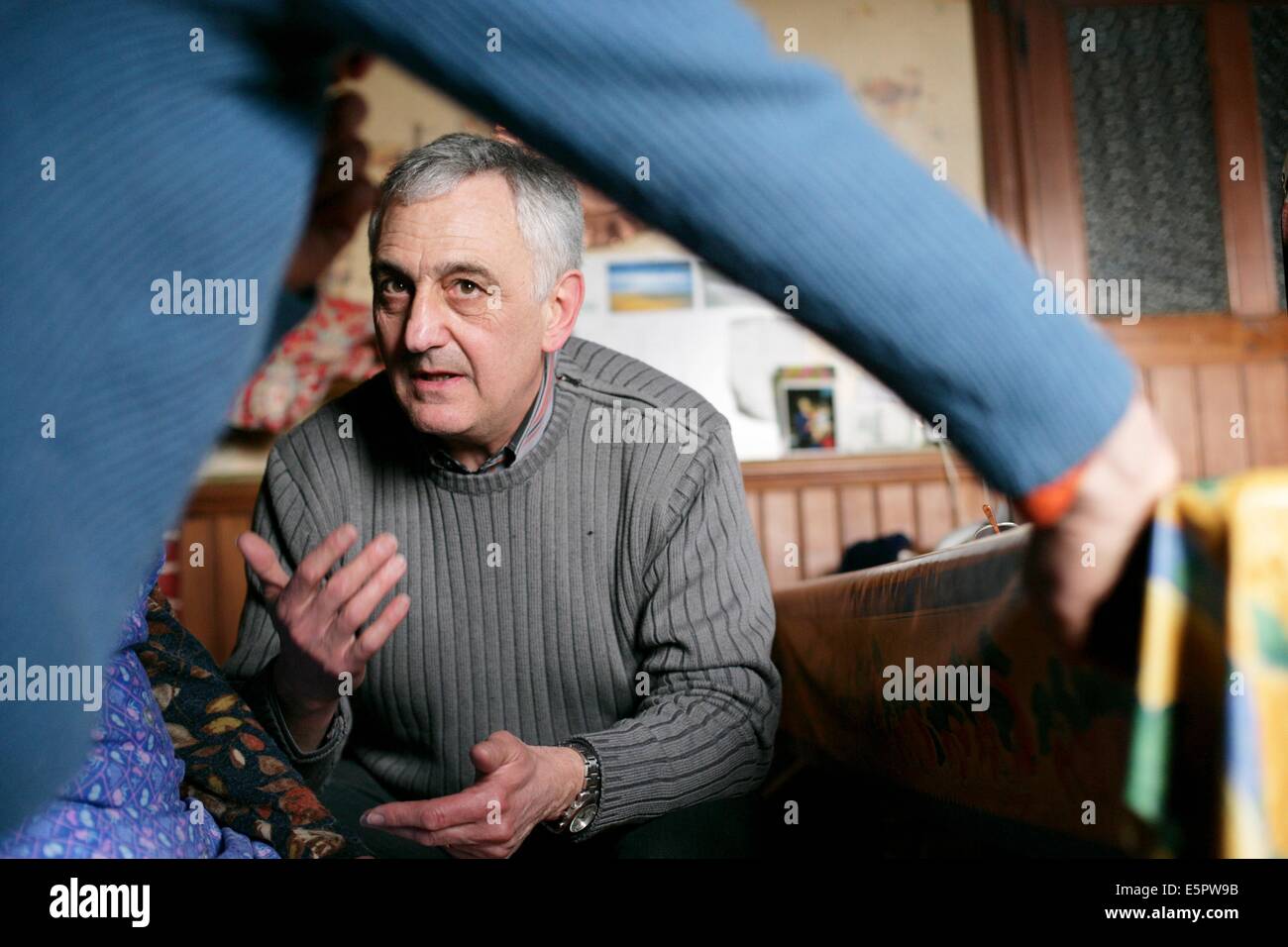General practitioner conversing with elderly patient during a home ...