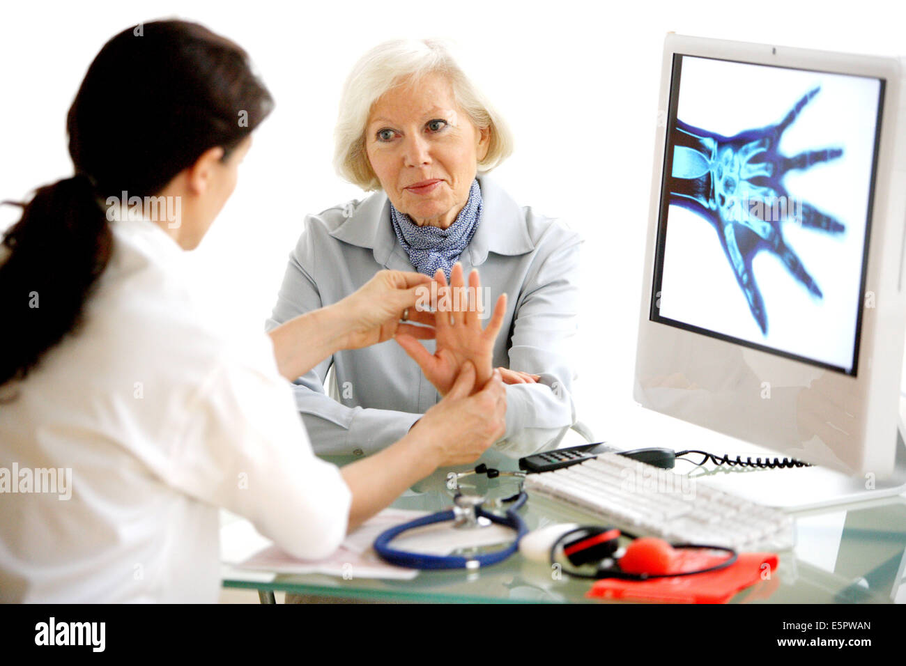 Doctor examining the hand of a patient Stock Photo - Alamy