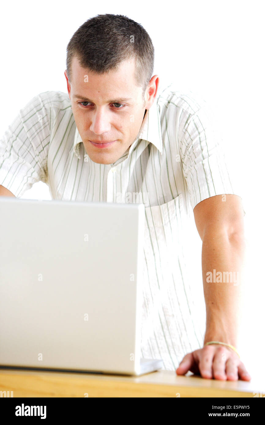 Man working on a laptop computer Stock Photo - Alamy