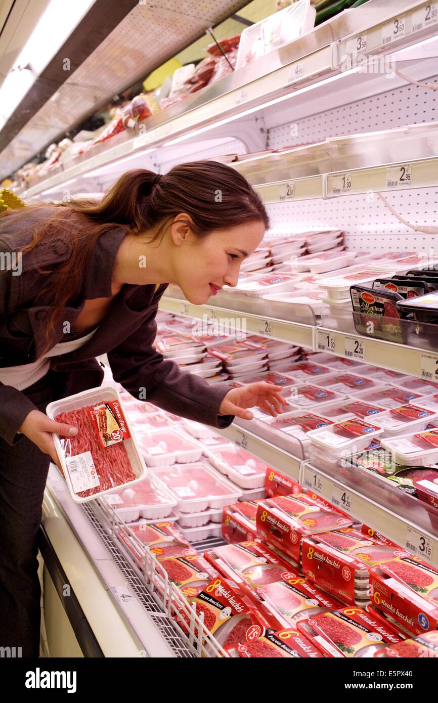 Woman shopping in the meat section in supermarket Stock Photo - Alamy