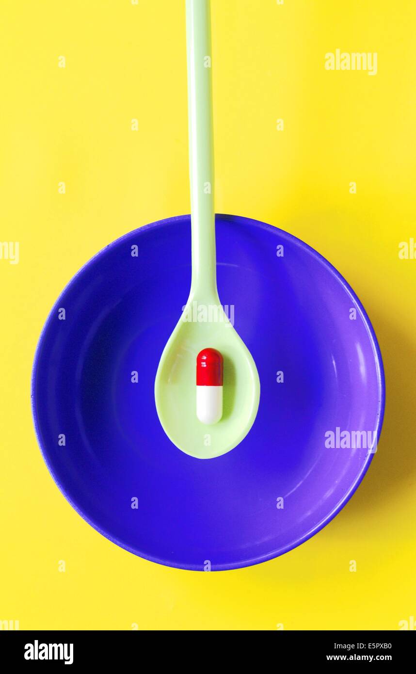 Drug capsule on spoon Stock Photo - Alamy