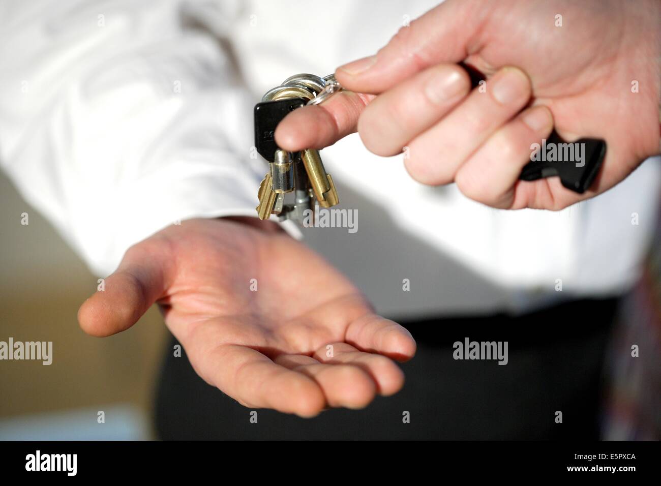 Hands passing on keys Stock Photo - Alamy